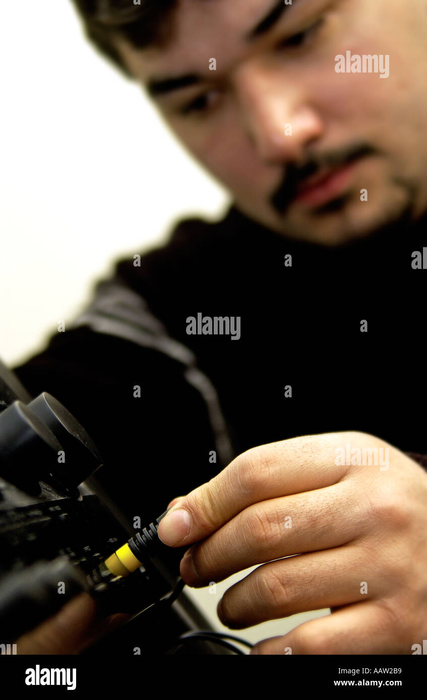 Man fixing stereo Stock Photo - Alamy