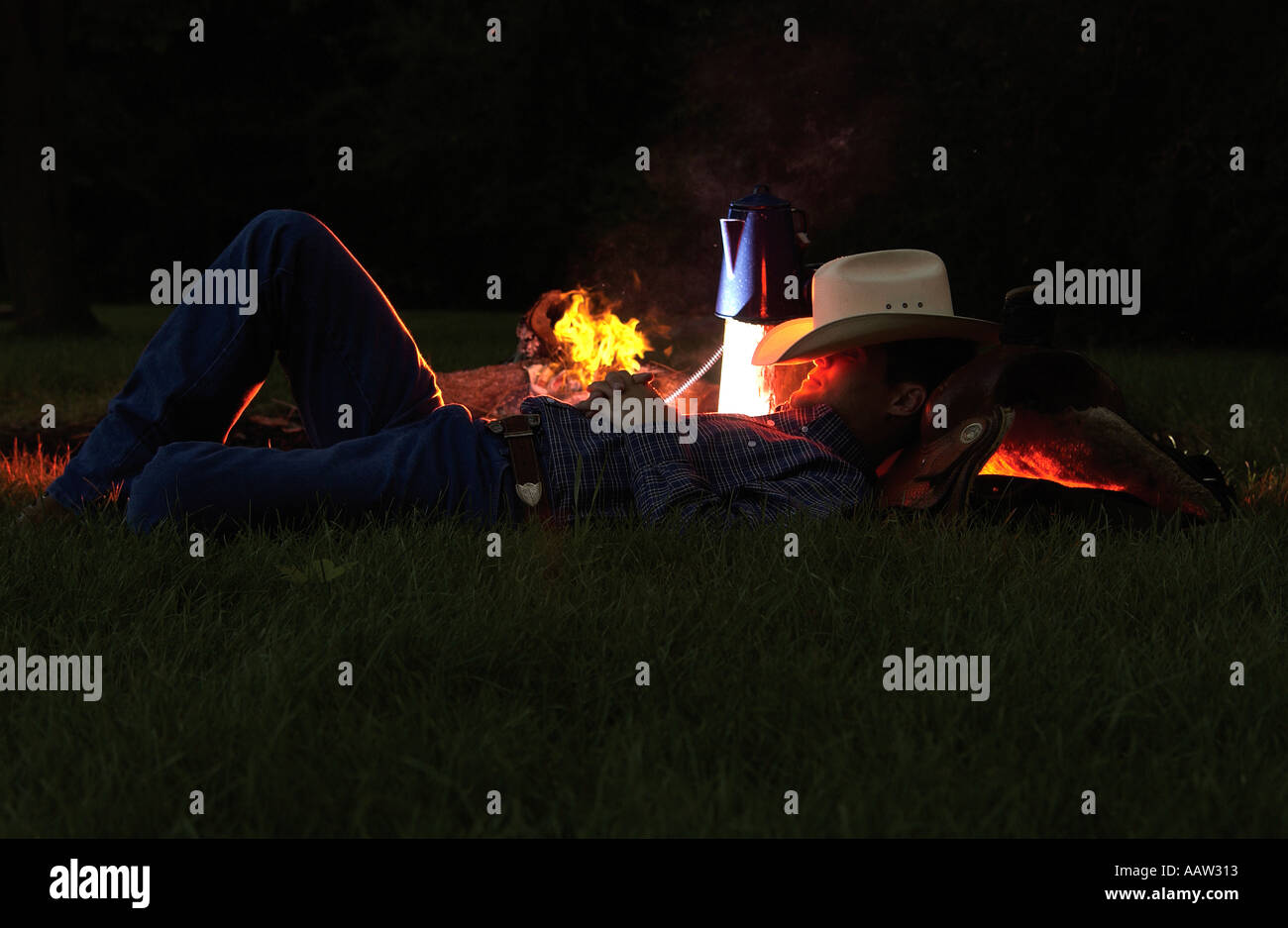 Cowboy near campfire Stock Photo - Alamy