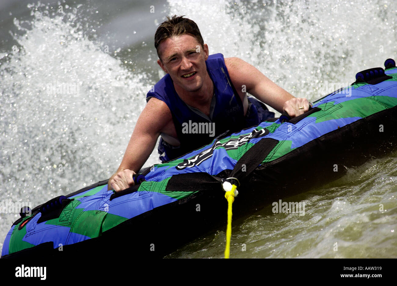 Man on inner tube Stock Photo - Alamy