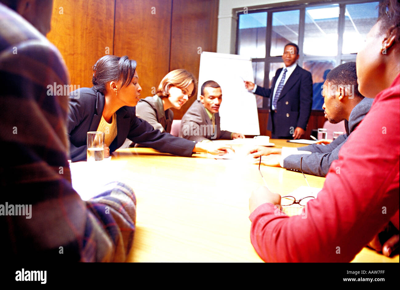 Multi ethnic business discussion in boardroom Johannesburg Gauteng ...