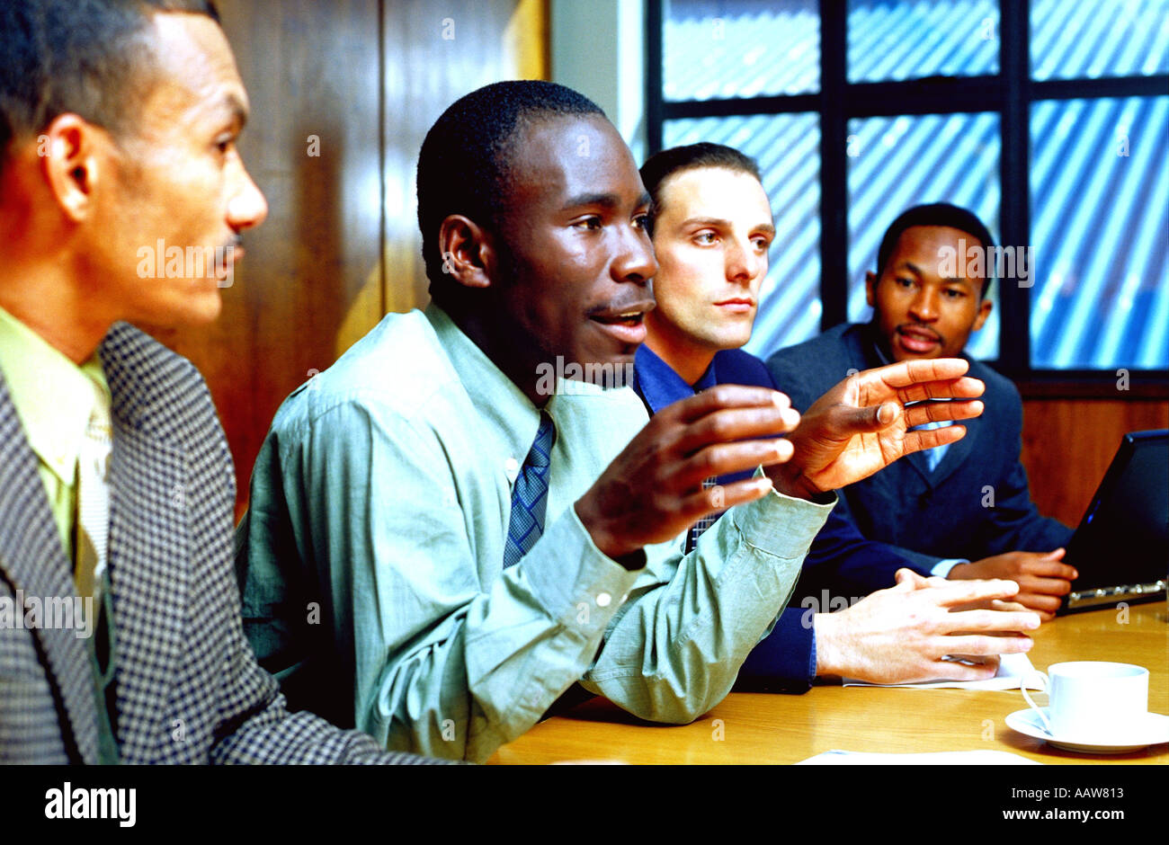 Multi ethnic business discussion in boardroom Johannesburg Gauteng ...