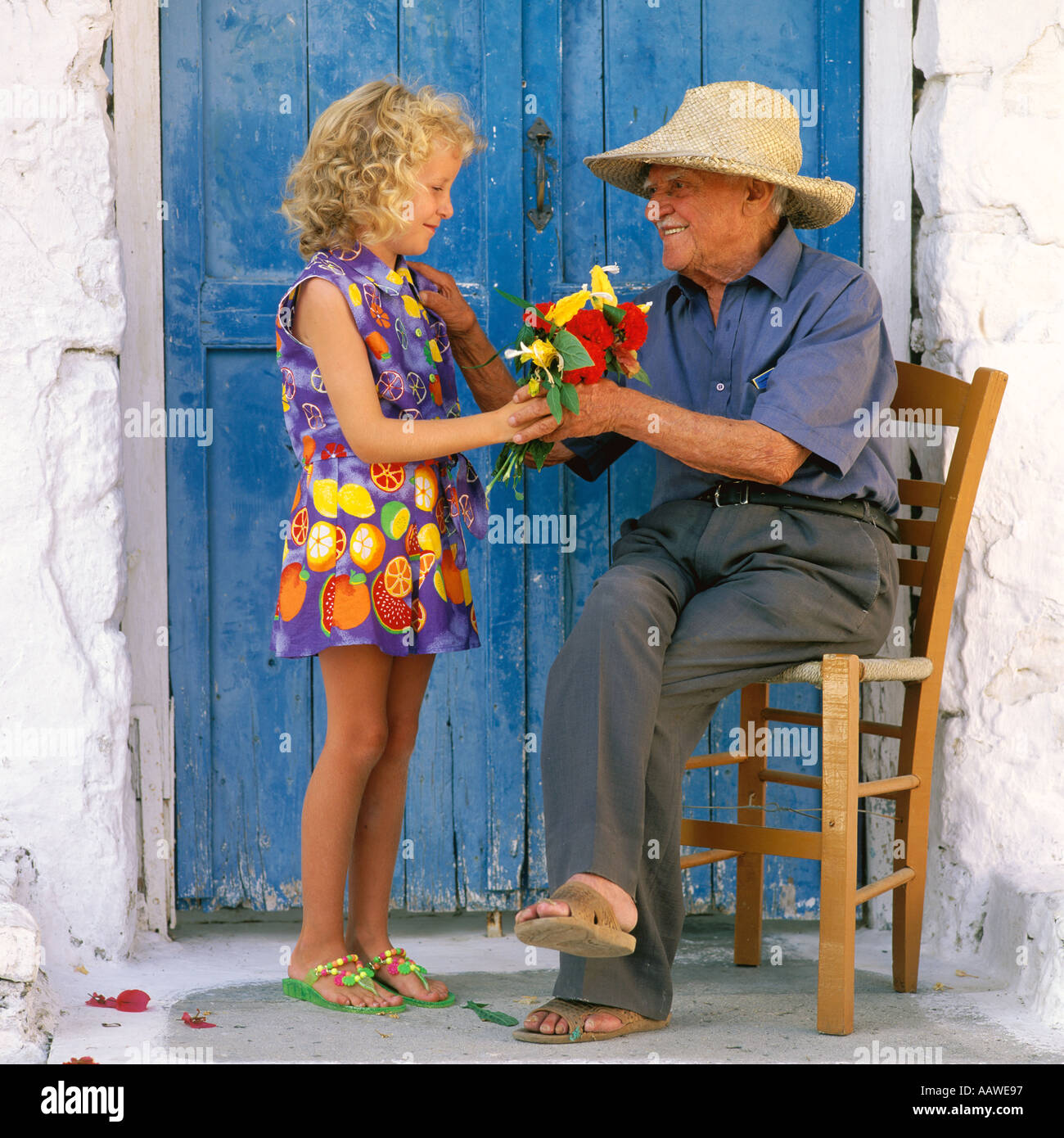 CHILD GIVING SENIOR GREEK MAN FLOWERS Stock Photo - Alamy