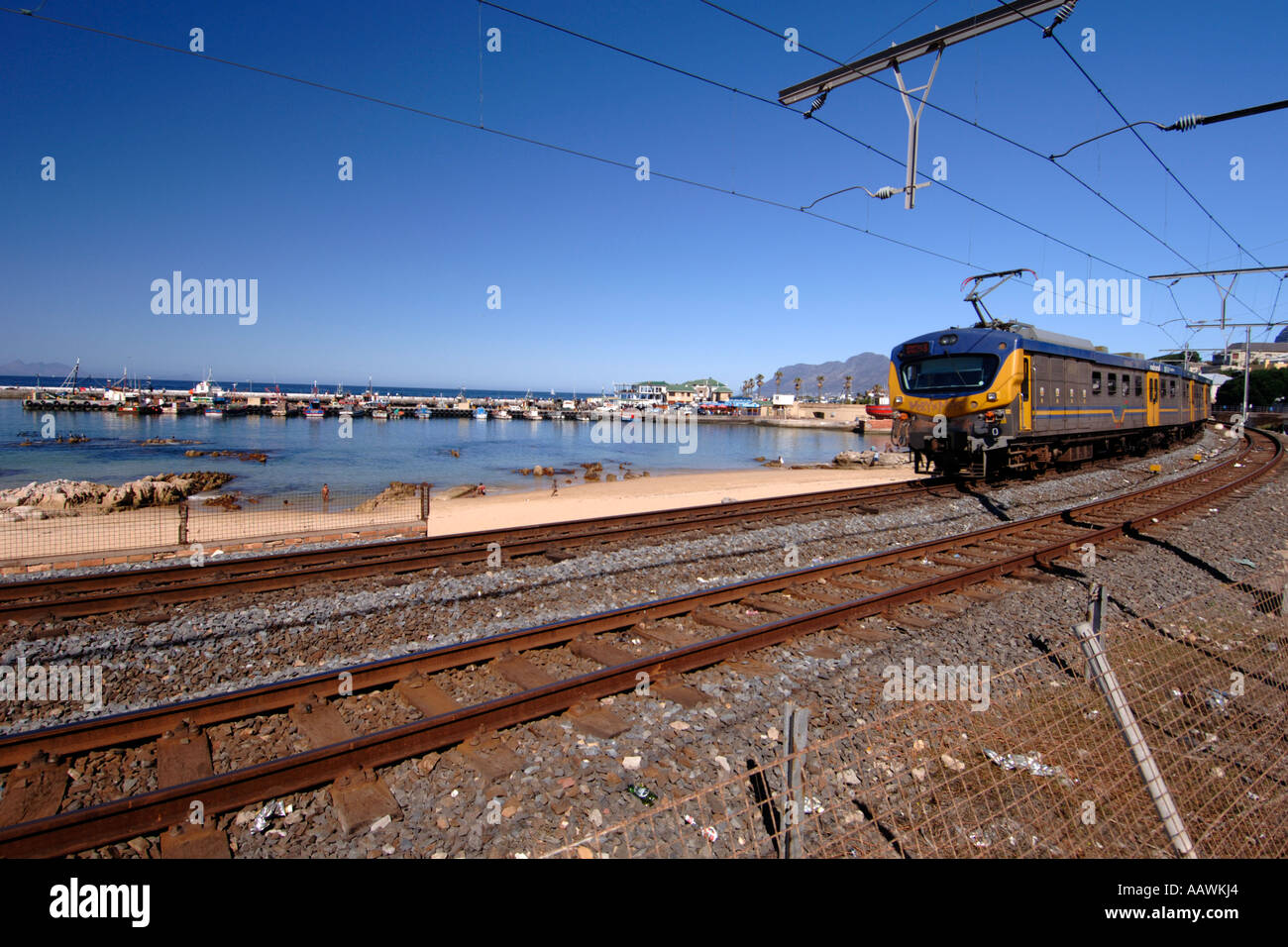 A train going past Kalk Bay harbour on Cape Town's Indian Ocean ...