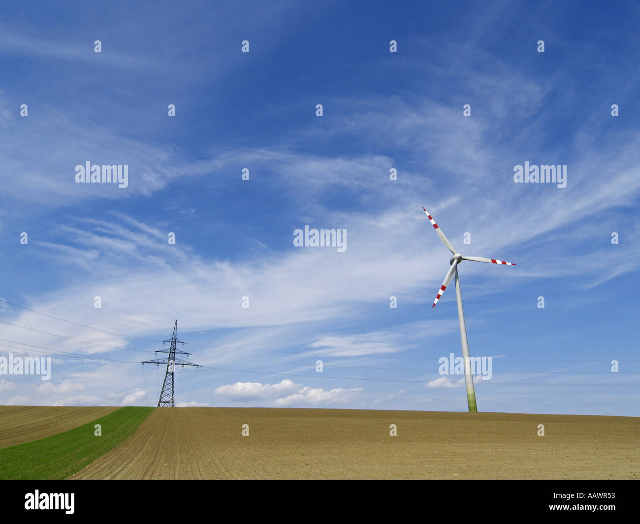 field with wind turbine and power pole Stock Photo - Alamy
