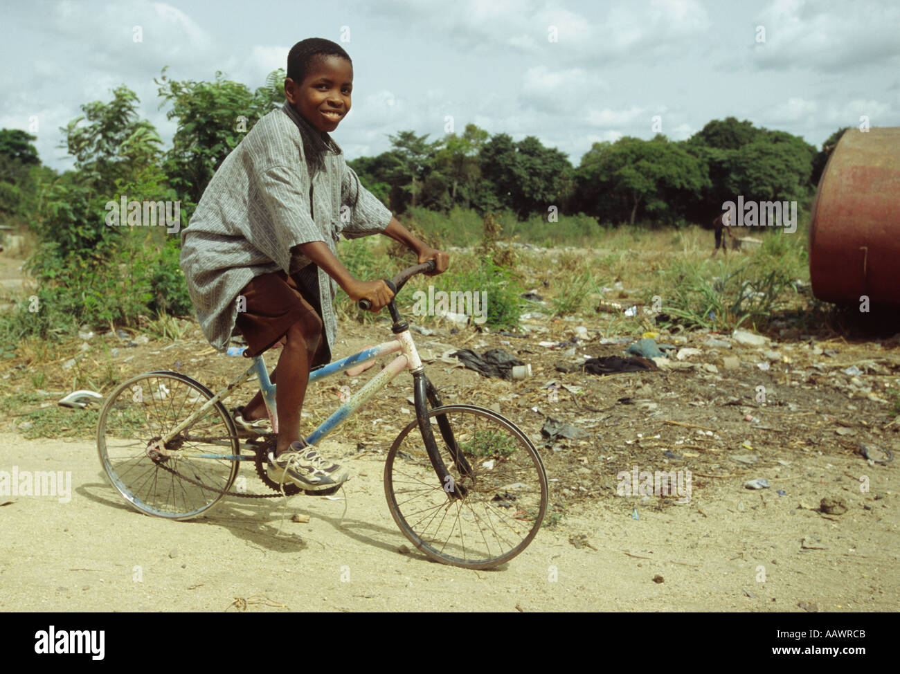 Liberian boy on a poor bike with no tyres Stock Photo - Alamy
