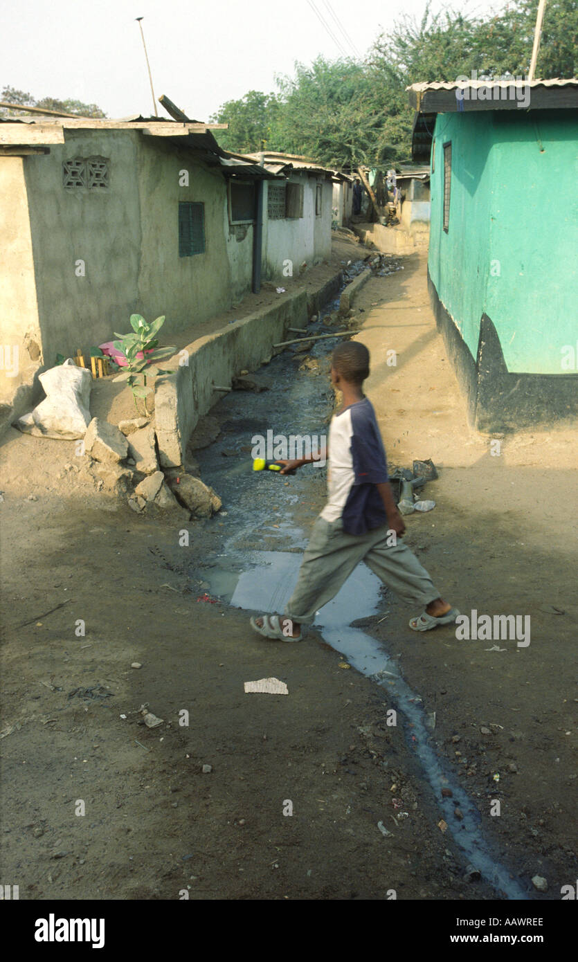Liberian boy crossing an open sewer drain Stock Photo - Alamy