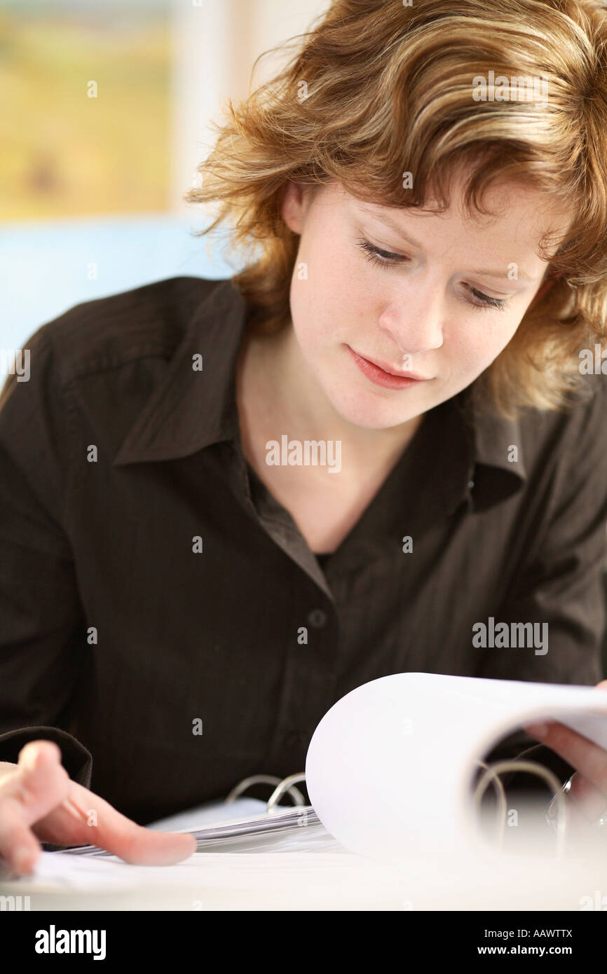 Woman in office reads hi-res stock photography and images - Alamy