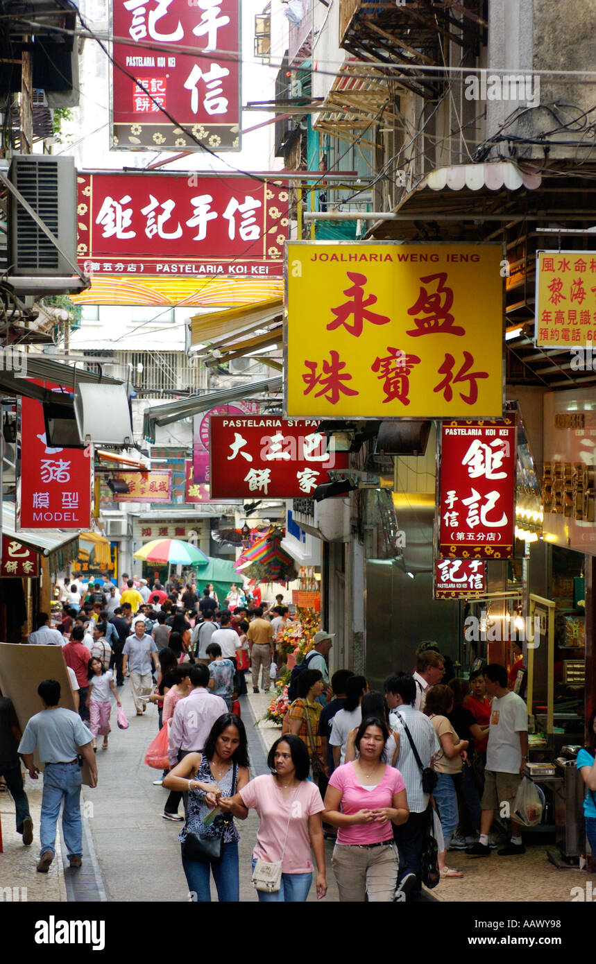 Crowds of visitors and tourists throng the narrow streets of Macau near ...