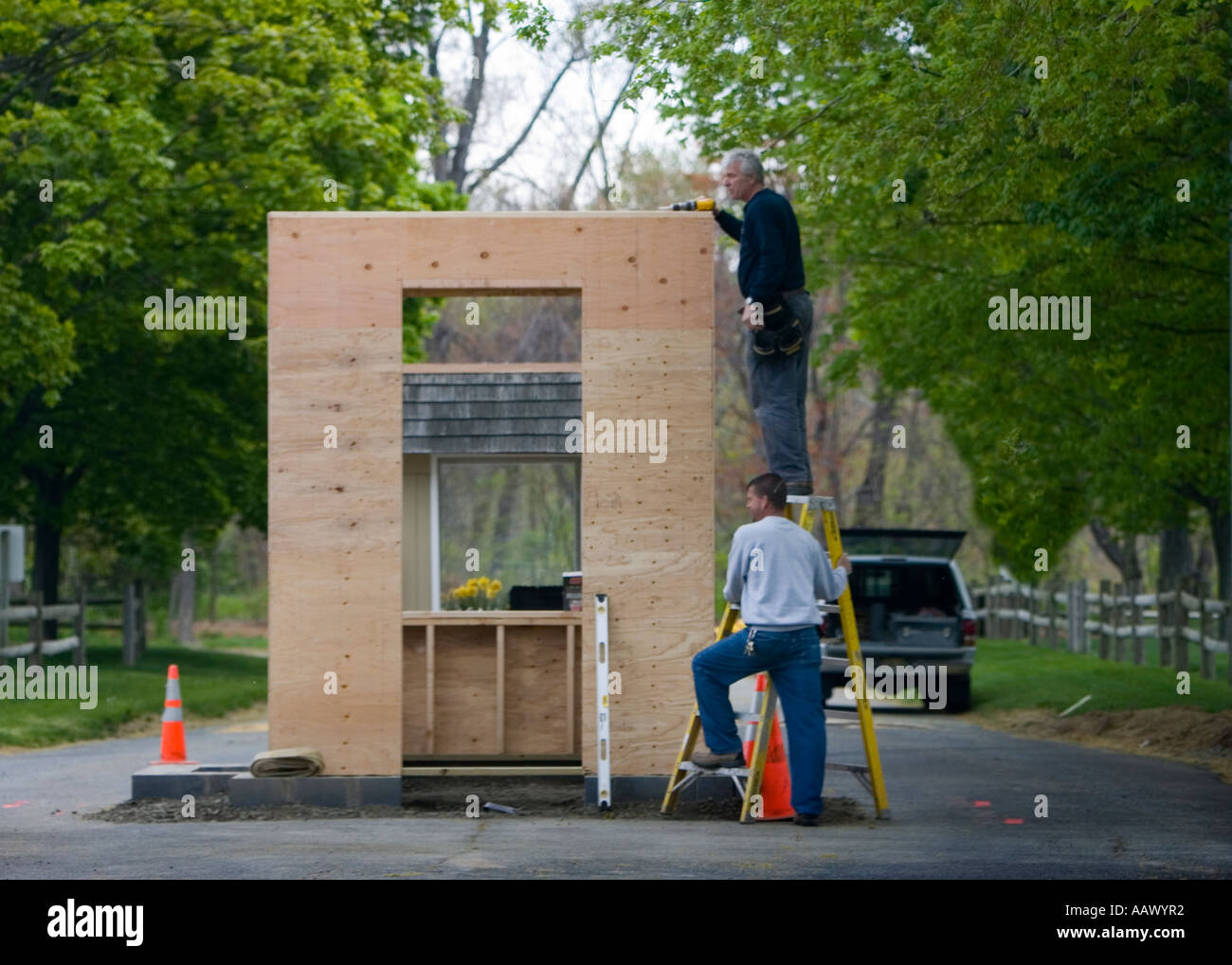 Workers building a gate house Stock Photo - Alamy