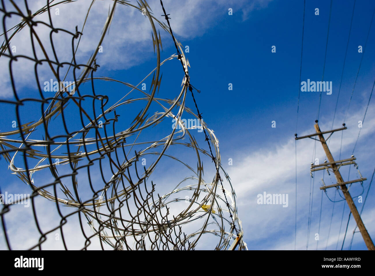 A fence with barbed wire on top Stock Photo - Alamy