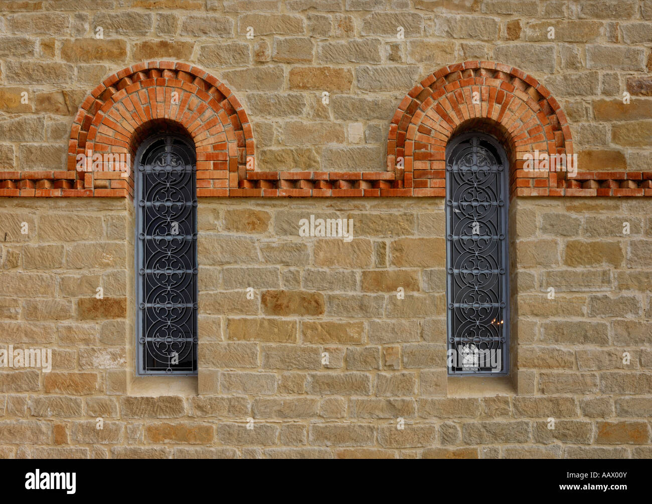 Arched narrow windows in a stone wall Architectural details texture ...