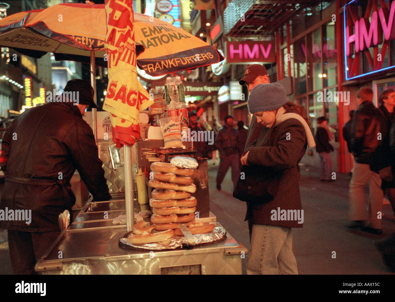 A woman buys a hot dog from a hot dog vendor on 42nd Street in Times ...