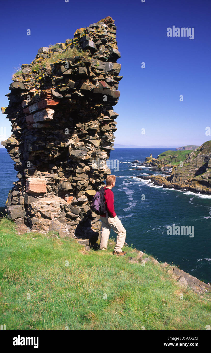 Coastal walks walker at remains of Fast Castle looking to Wheat Stack ...