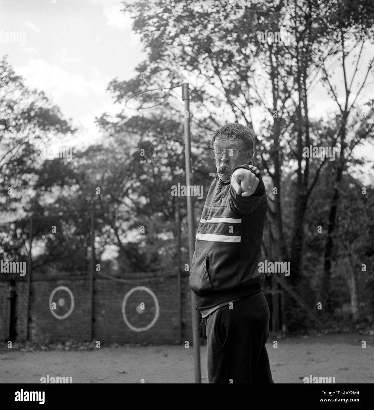 a sports teacher blowing a whistle POSED BY MODEL Stock Photo - Alamy