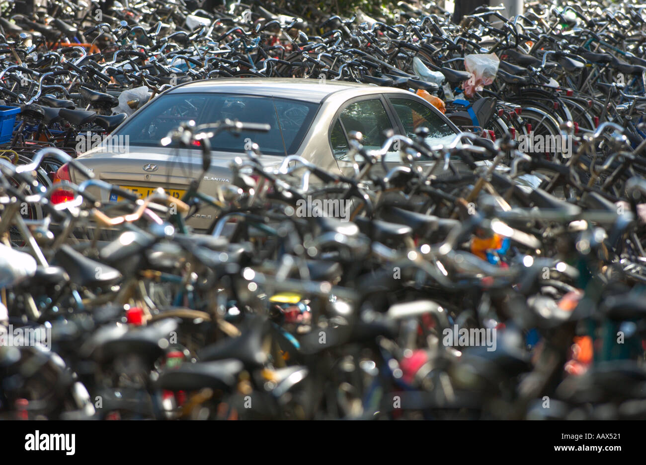 car disappearing in a sea of parked bicycles outside the central train ...