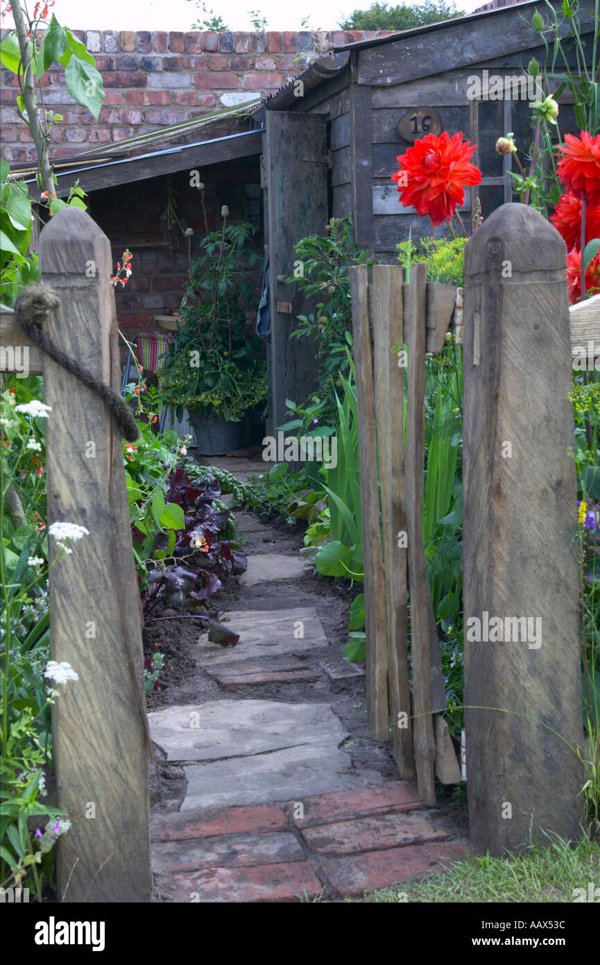 path to garden shed on allotment with dahlias and vegetables Stock ...