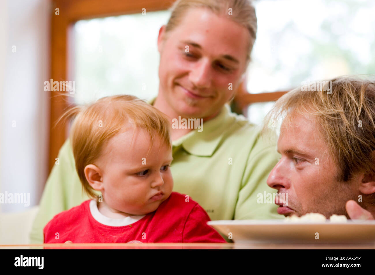 Two Men with Baby Stock Photo - Alamy