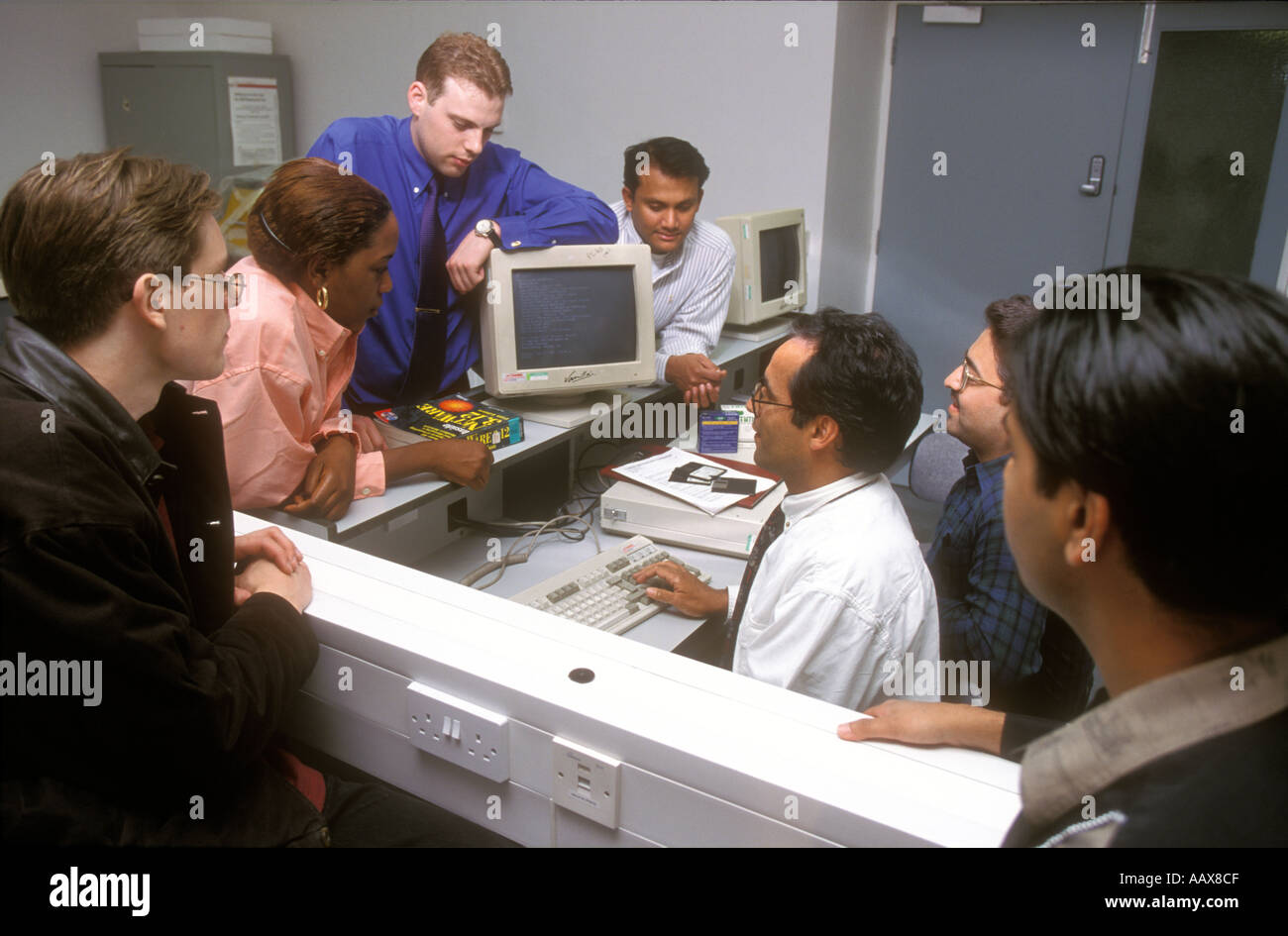 Group of university students having a discussion with tutor Stock Photo ...