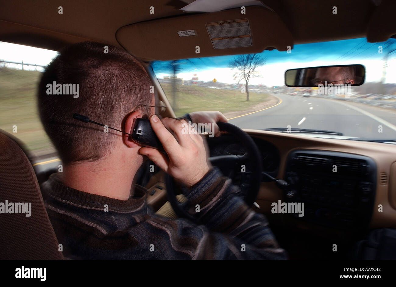 Man talking on cell phone while driving a car with one hand man teen ...