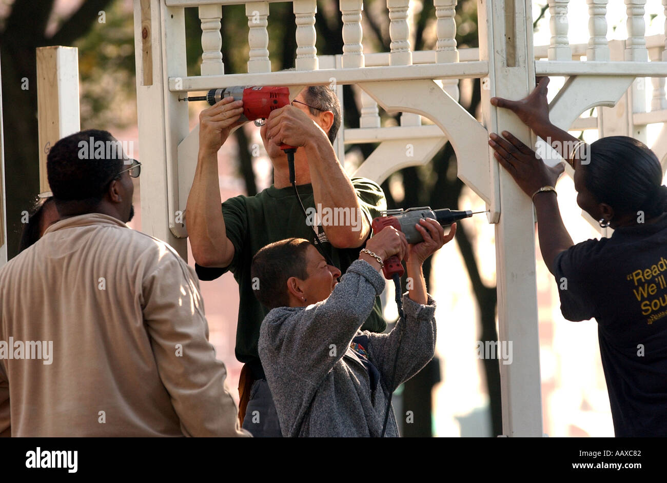 People working building a community project on a town green man using ...