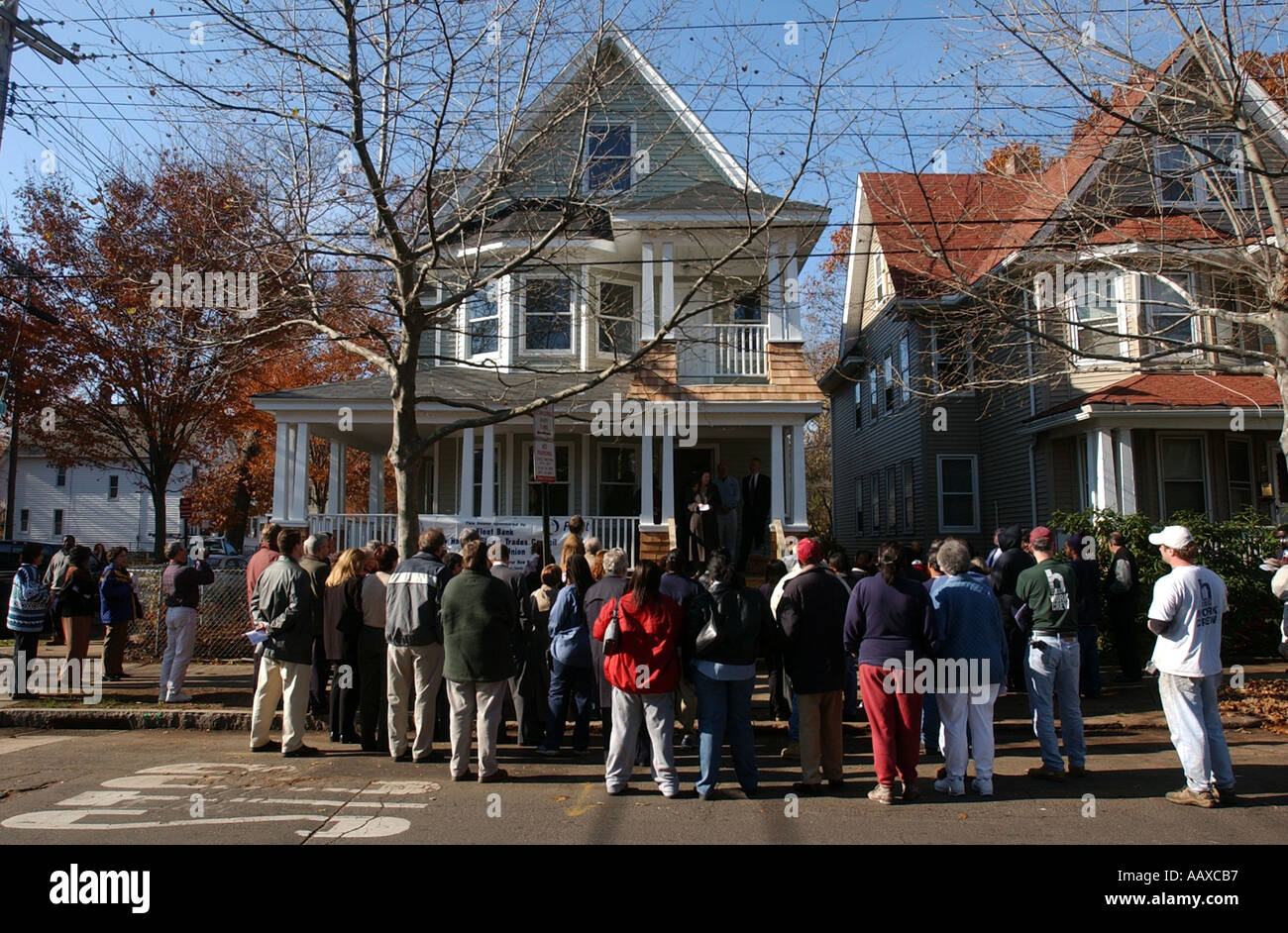 People standing around a large inner city house home during a ...