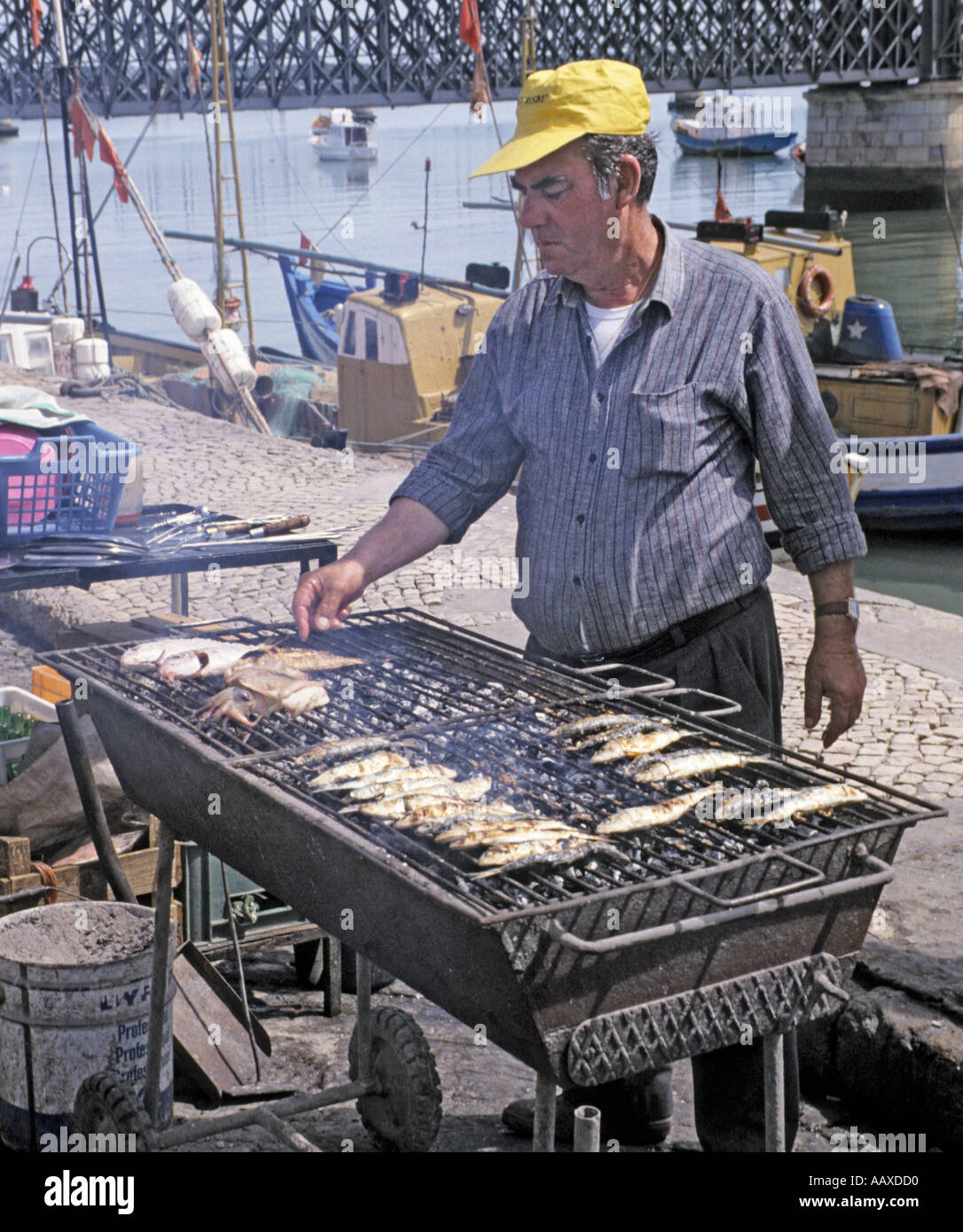 Man cooking sardines hi-res stock photography and images - Alamy