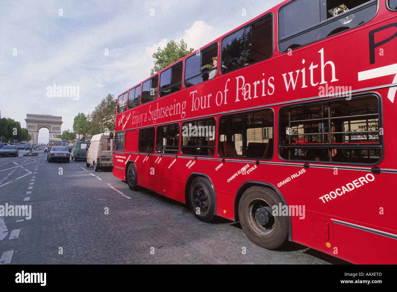 Red tour bus on Champs Elysees with Arc de Triomphe Stock Photo - Alamy