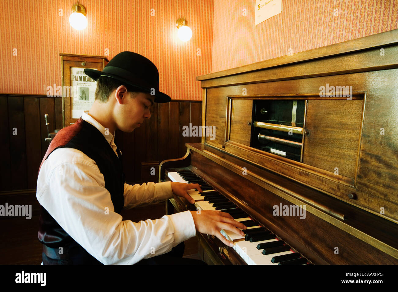 Musician playing old fashioned piano Stock Photo - Alamy