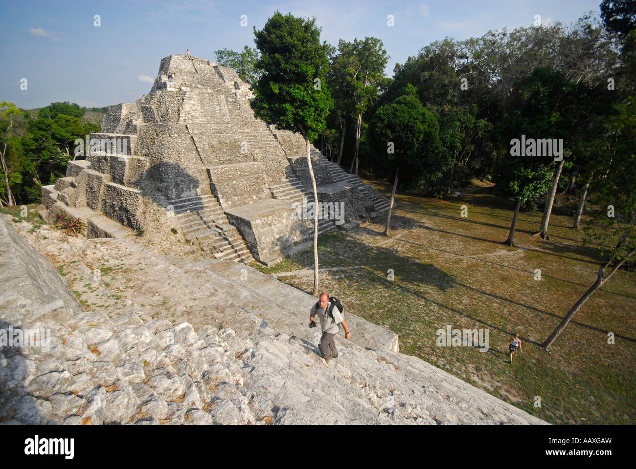 Tourist ascending to pyramid in Yaxha Ruins site, Peten, Guatemala ...