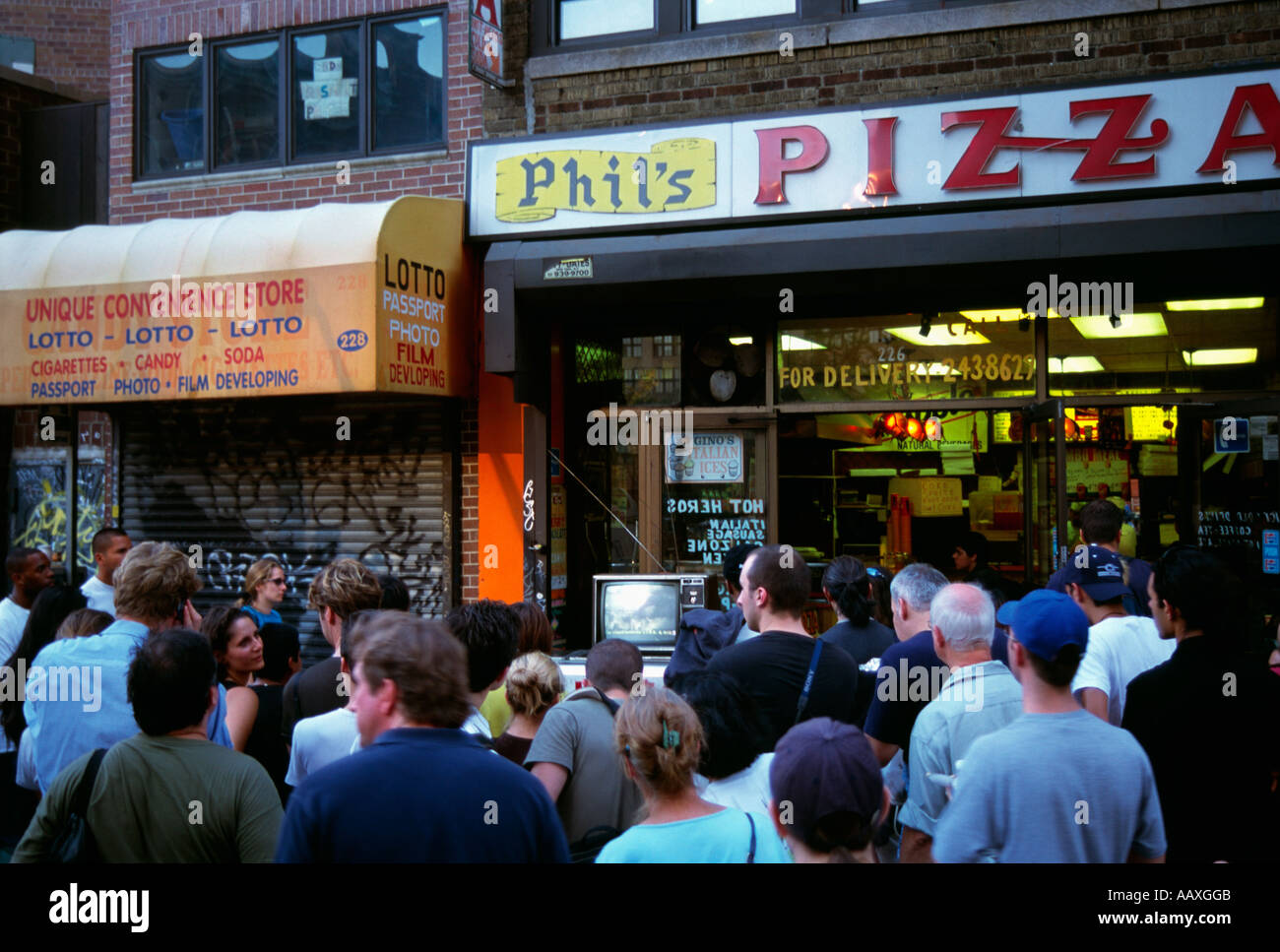 Crowds of people standing on the street watching news broadcasts on 9 ...