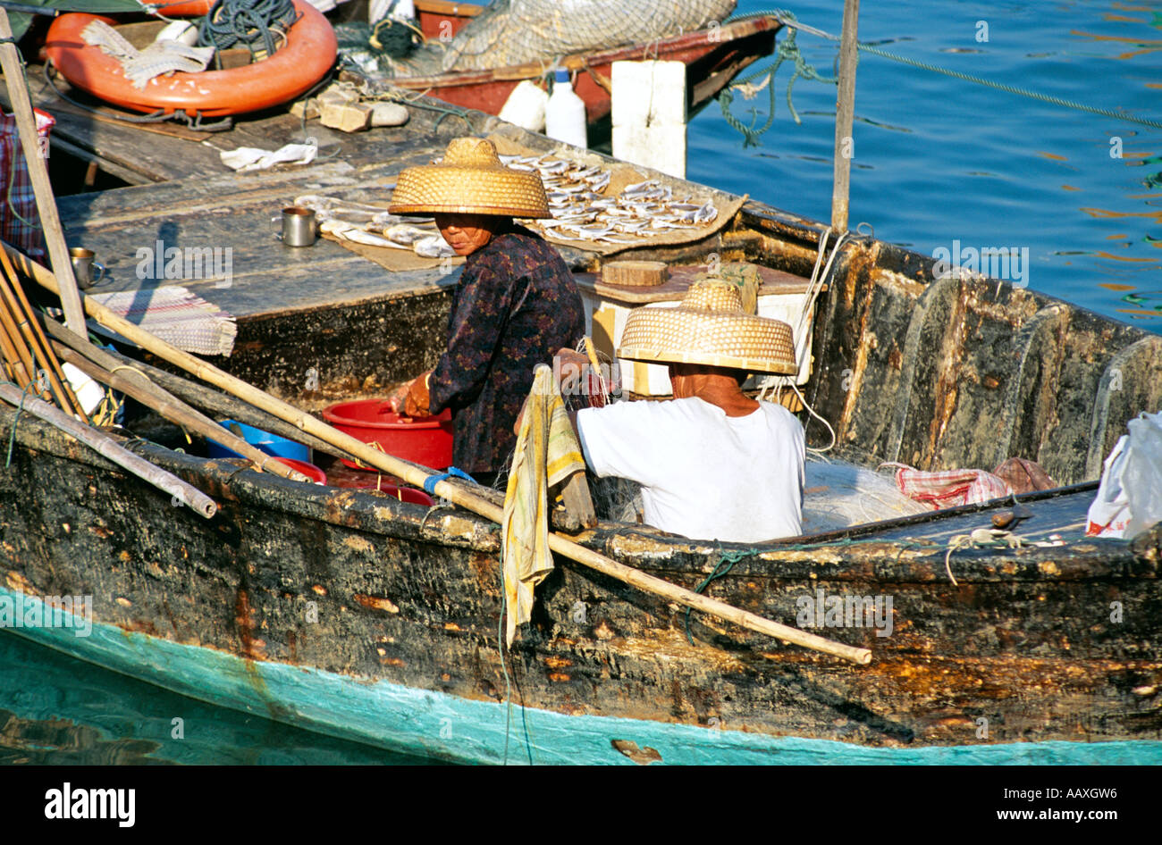 Woman cleaning fish on fishing boat, Cheung Chau Island, Hong Kong ...