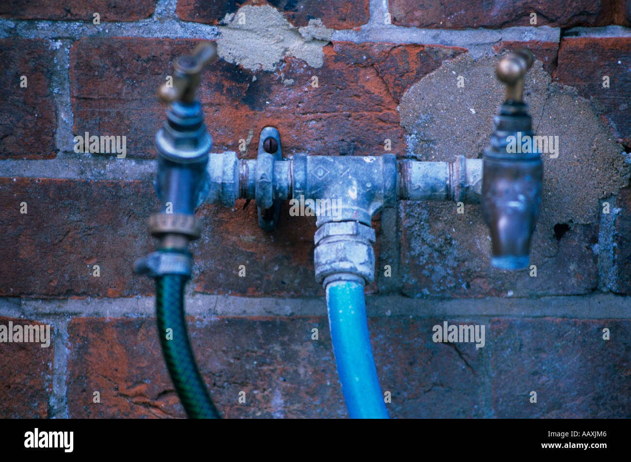 dripping old taps in a garden in England sewage plumbing and ...