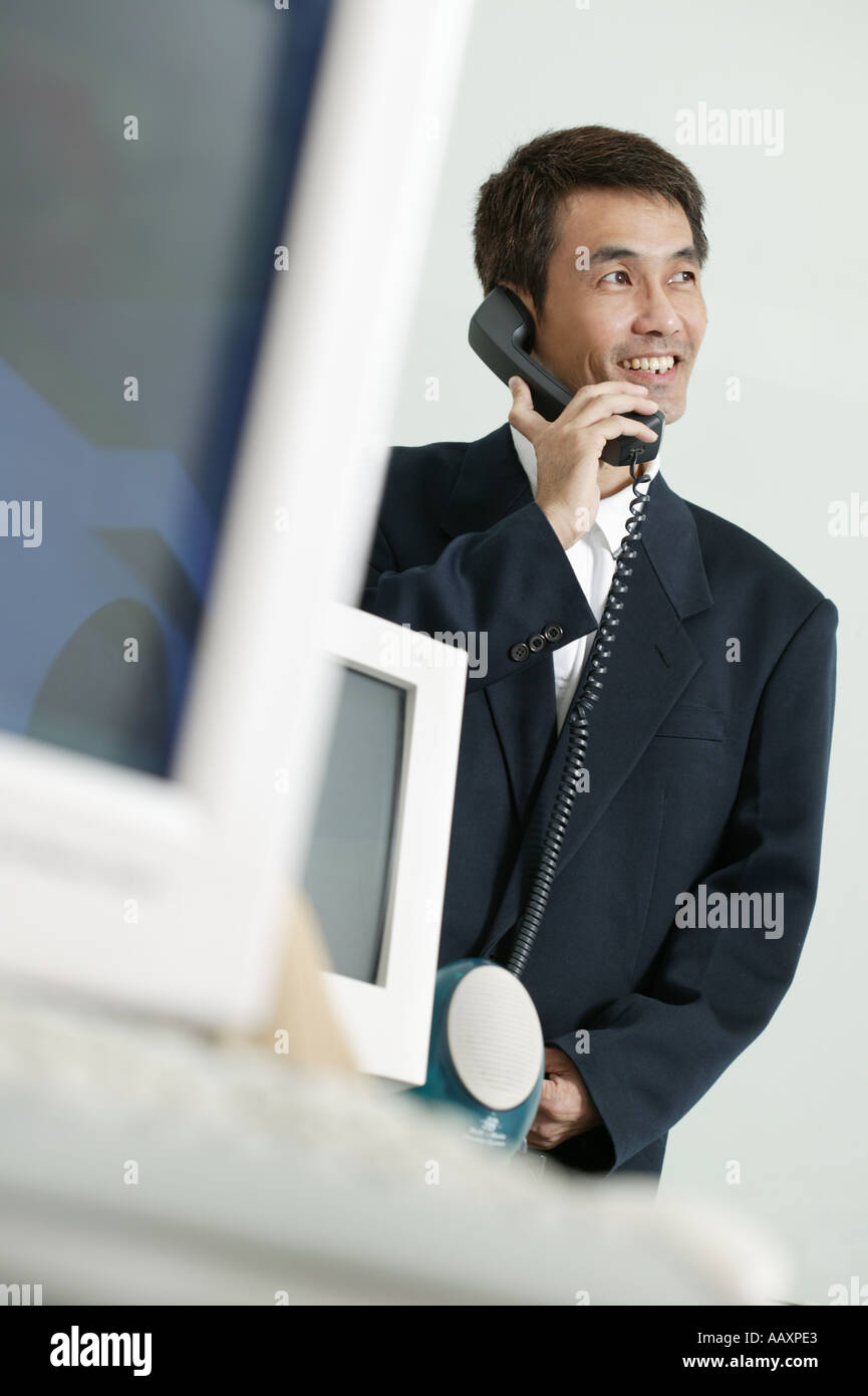 Office Man behind the Computer Talking on the Phone Stock Photo - Alamy