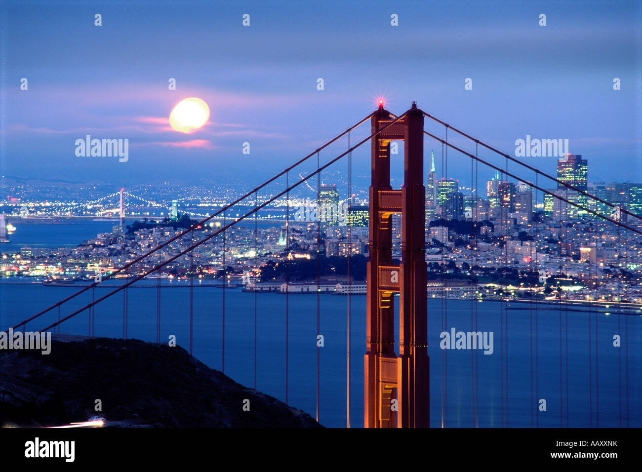 Golden Gate Bridge at twilight on a clear day with full moon in San ...