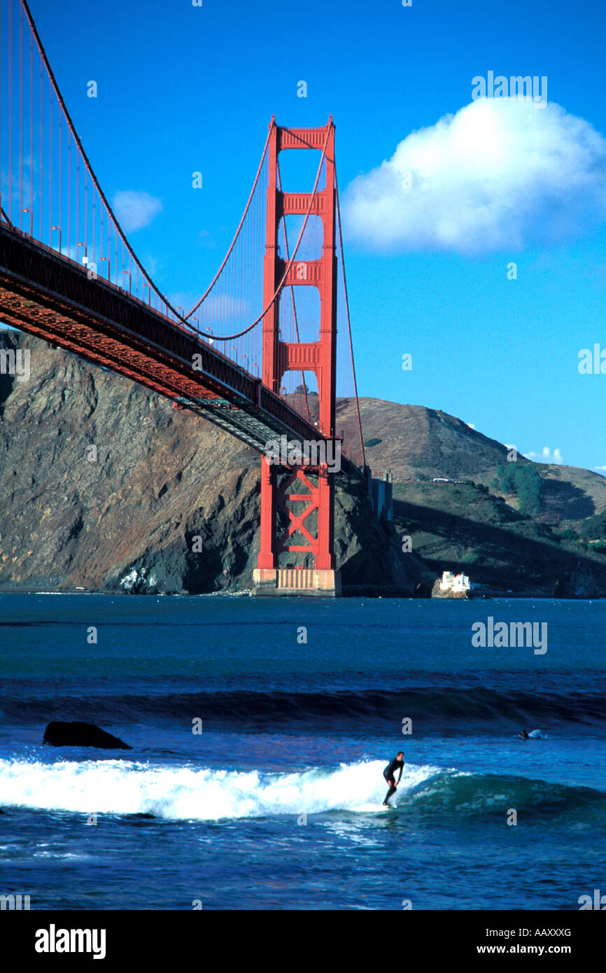 surfer surfing waves at Golden Gate Bridge in San Francisco California ...