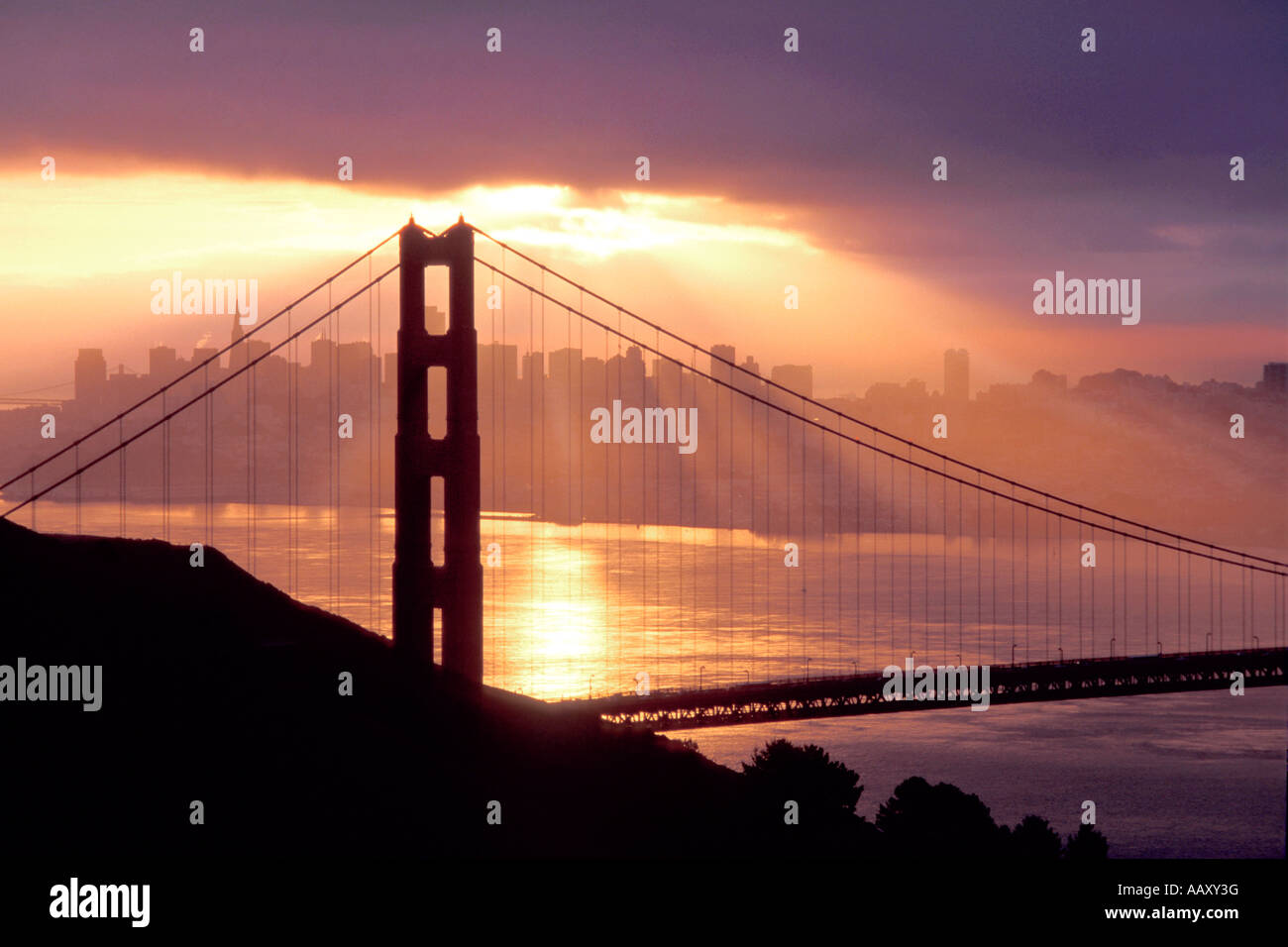 Golden Gate Bridge with god rays of dramatic light from storm clouds ...