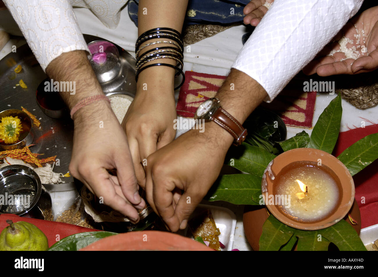 Indian wedding ceremony, bride and bridegroom with father doing Kalash ...