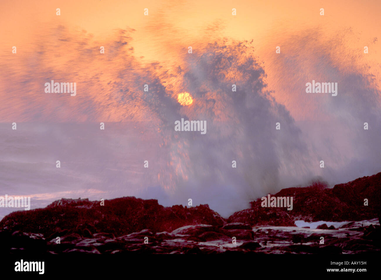 giant wave crashing onto rocks along the California coast and the ...
