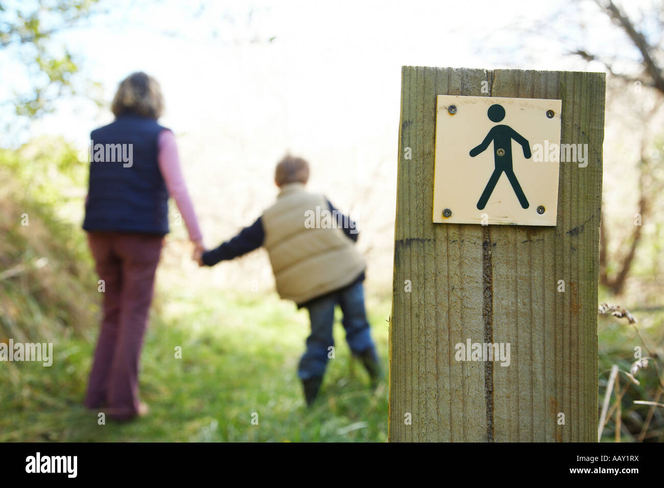 mother and child walking a doc track with sign Stock Photo - Alamy