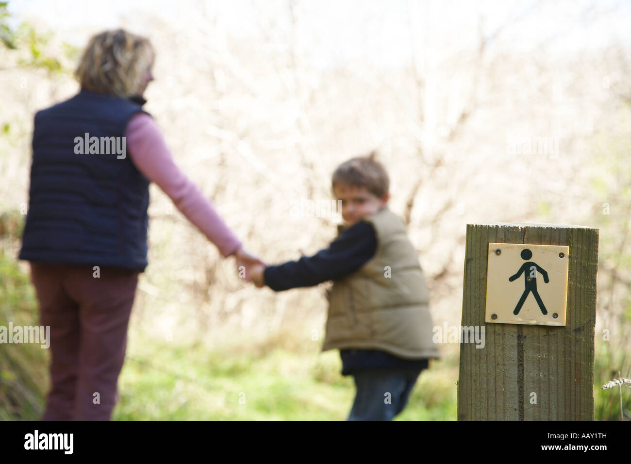 mother and child walking a doc track with sign Stock Photo - Alamy