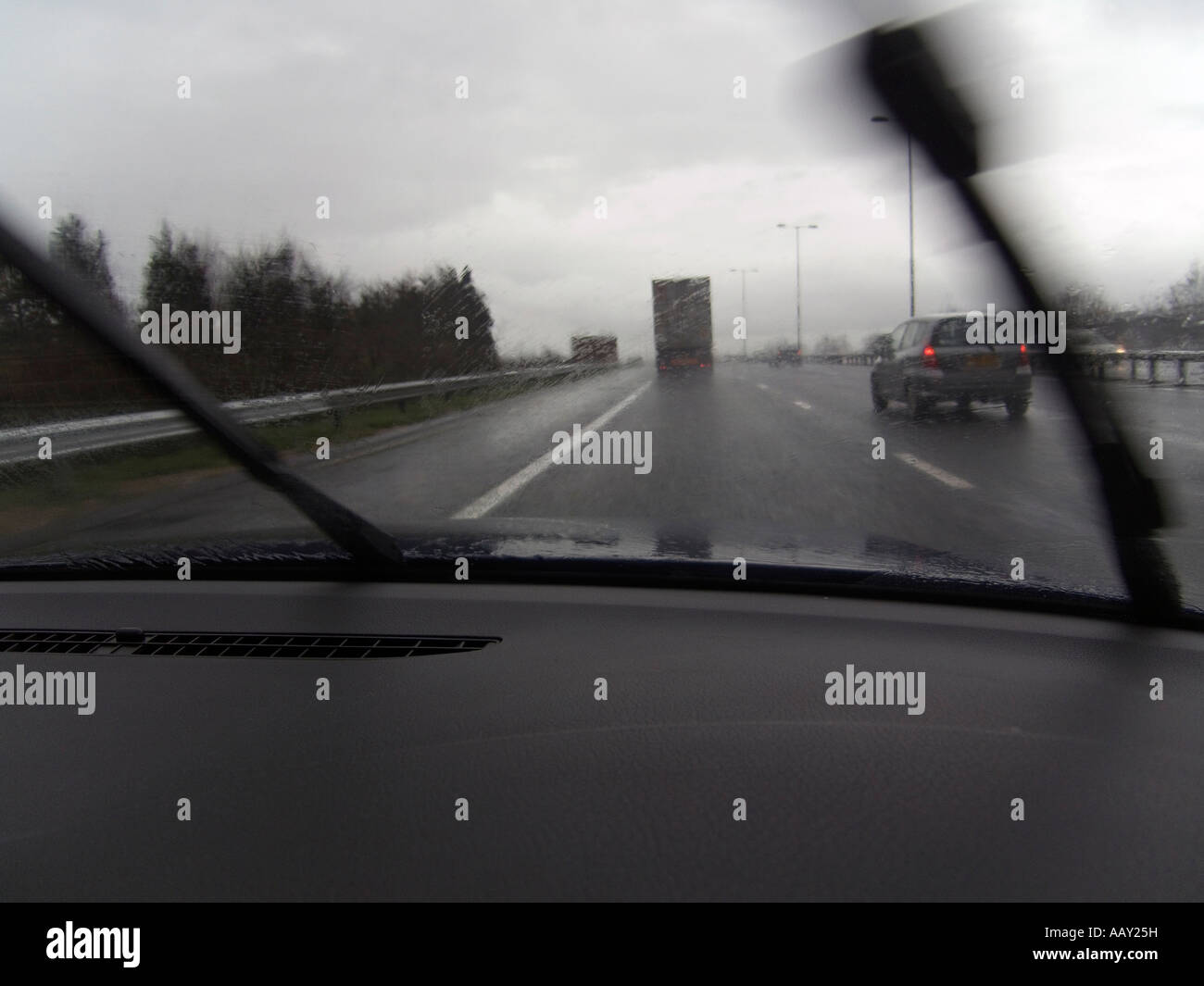Windscreen wipers through car window, stormy weather Stock Photo - Alamy