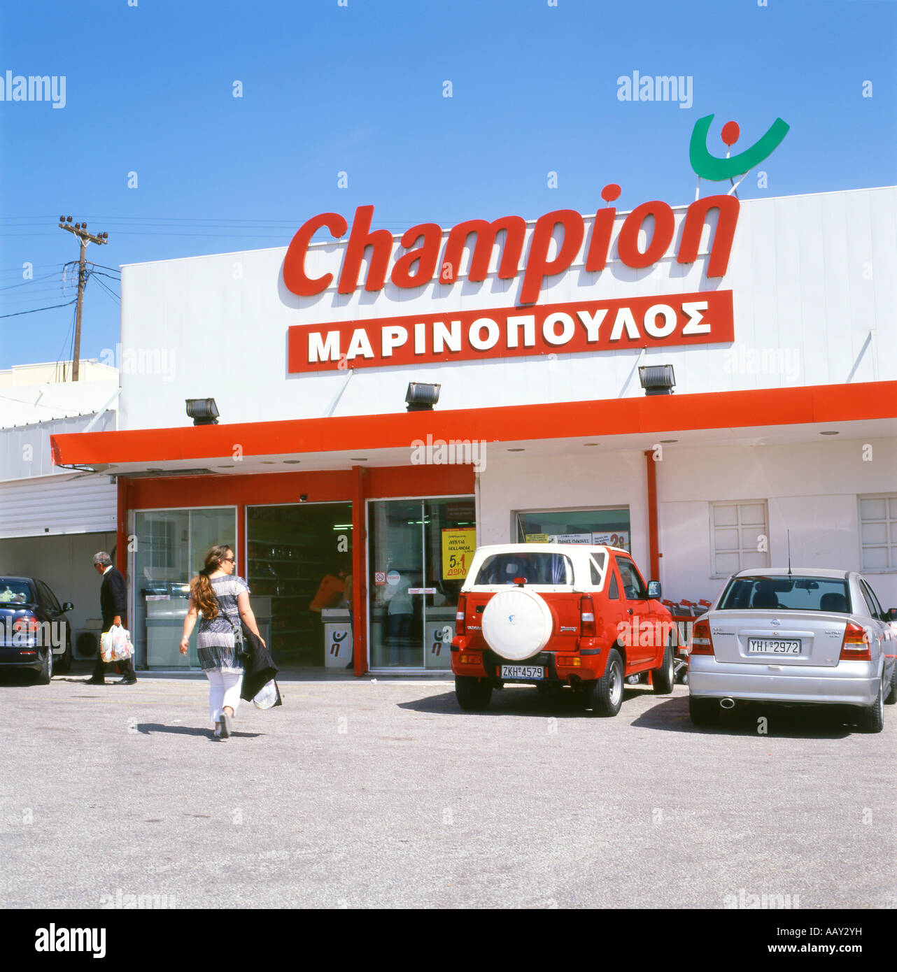 A customer entering the Champion Supermarket, Fira, Santorini Stock ...
