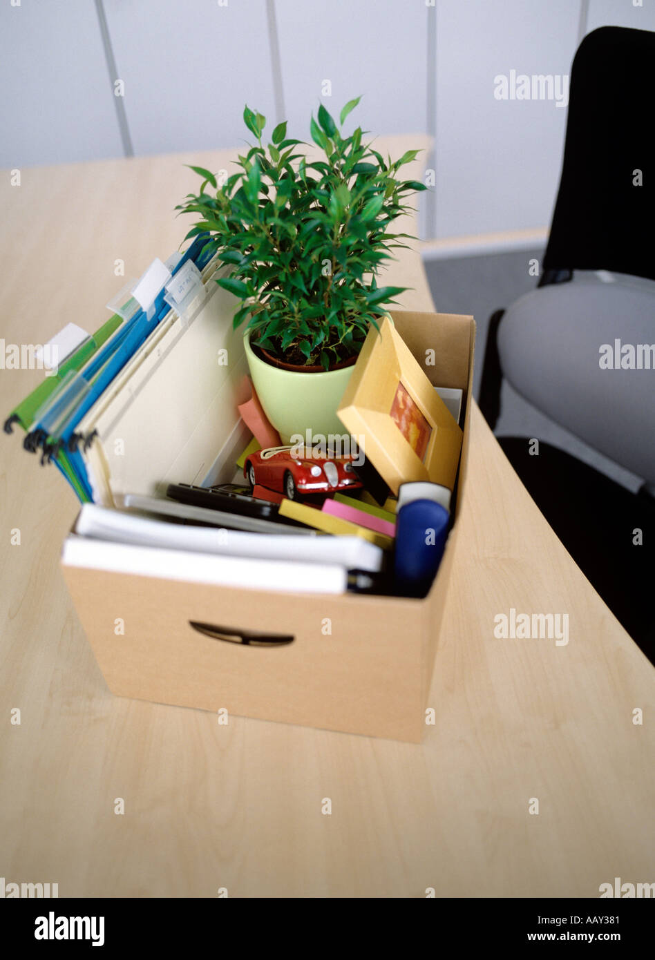 cardboard box with personal objects on empty office desk Stock Photo ...