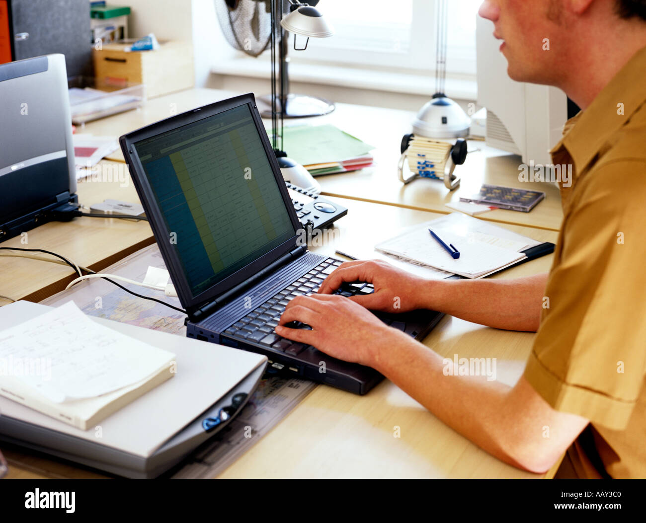 male office worker at office desk typing with laptop PC Stock Photo - Alamy