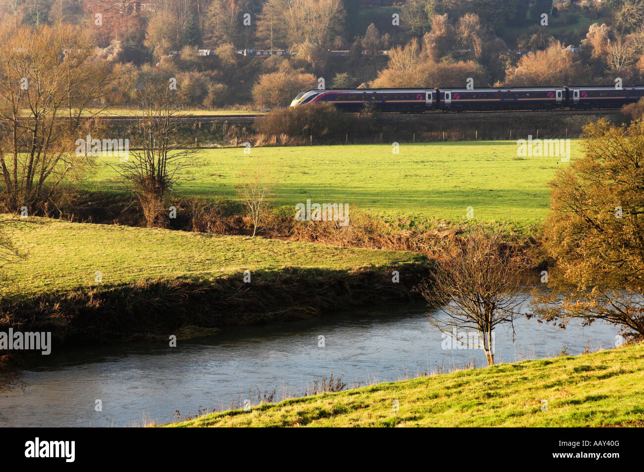 High speed train crossing countryside by river Avon near Monkton Combe ...