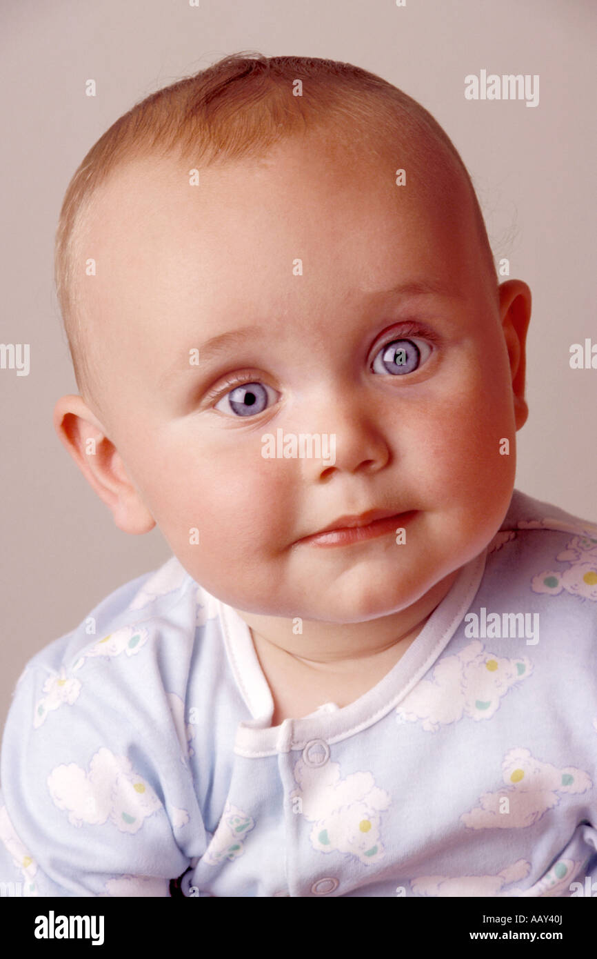 cute kid baby face expression with blue eyes and a sincere honest look ...