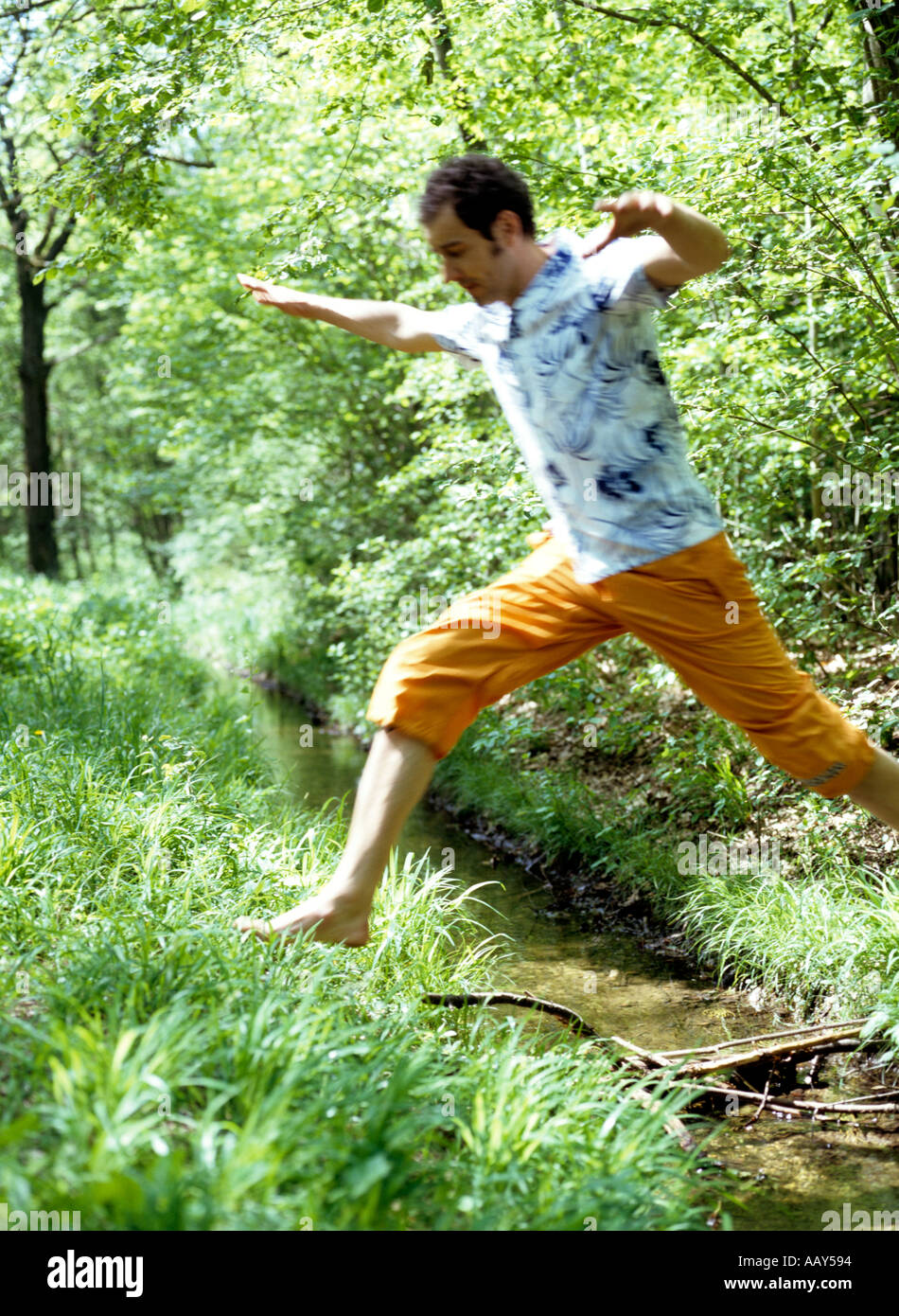 Man jumping over stream hi-res stock photography and images - Alamy