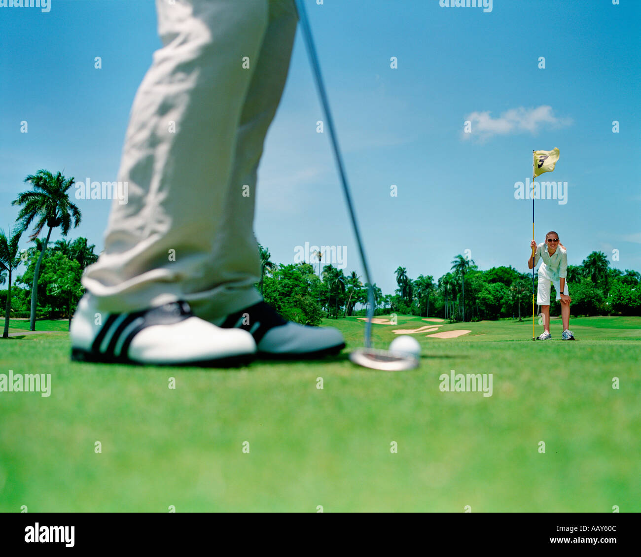 blurred detail shot of a golfer s feet with putter and golf ball Stock ...