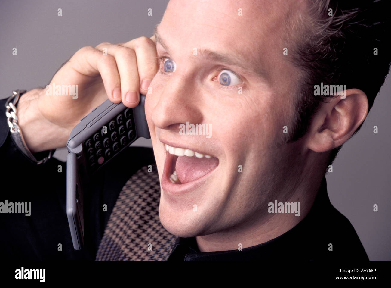Happy man talking on phone Stock Photo - Alamy