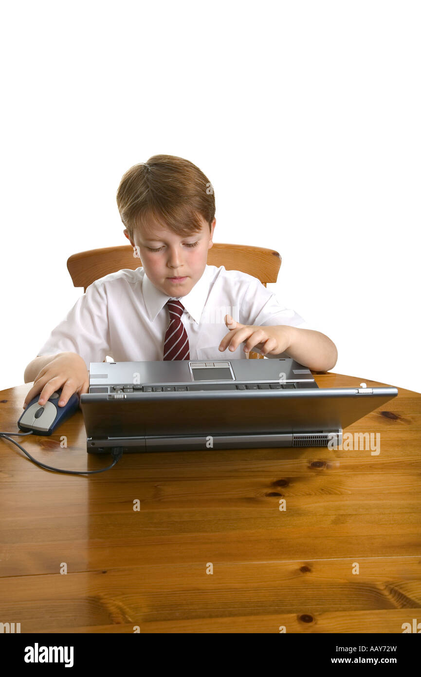Education shot of a Young schoolboy using a laptop sat at a desk ...